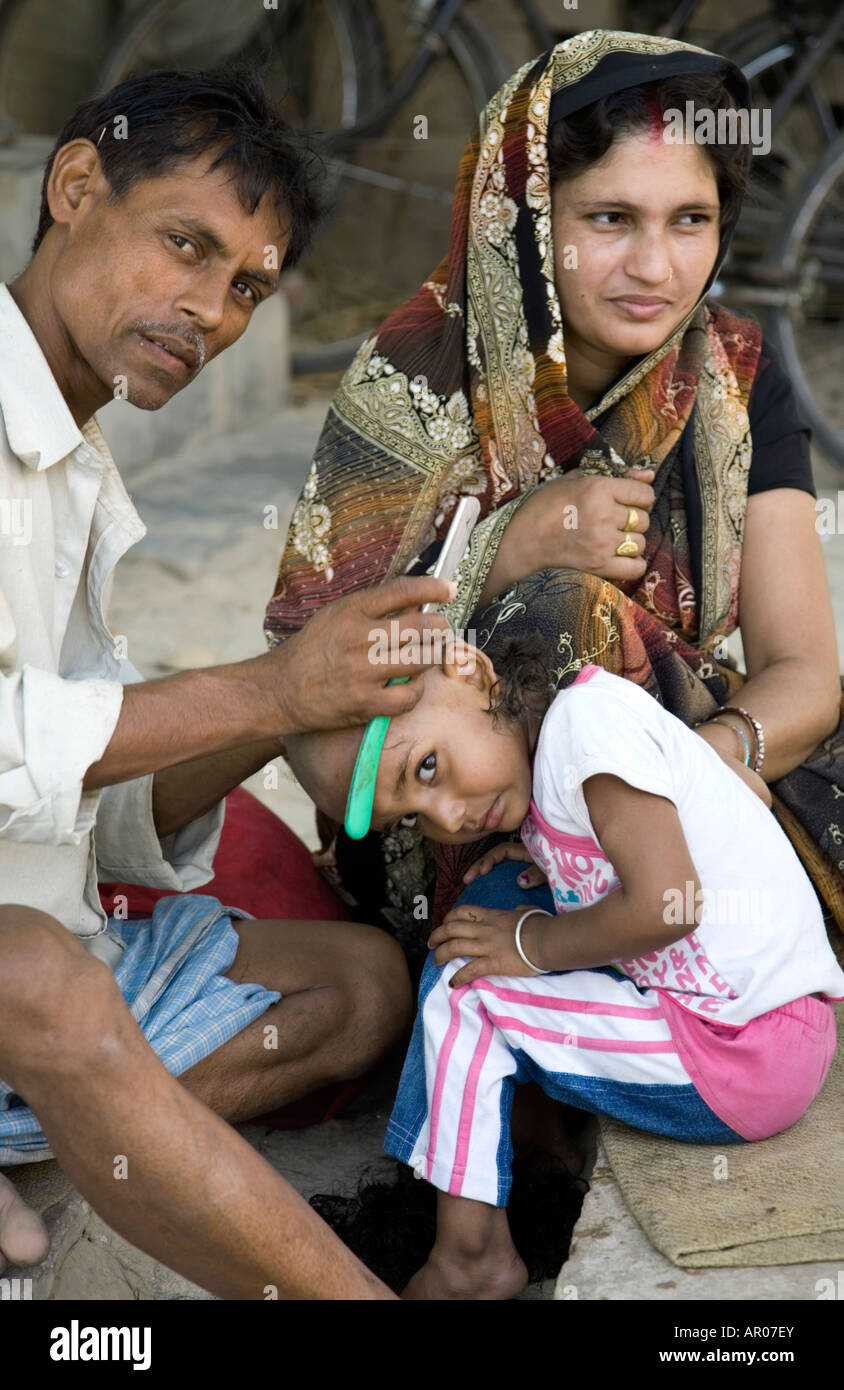 Street barber shaving the head of a boy.Traditional hindu purification ...
