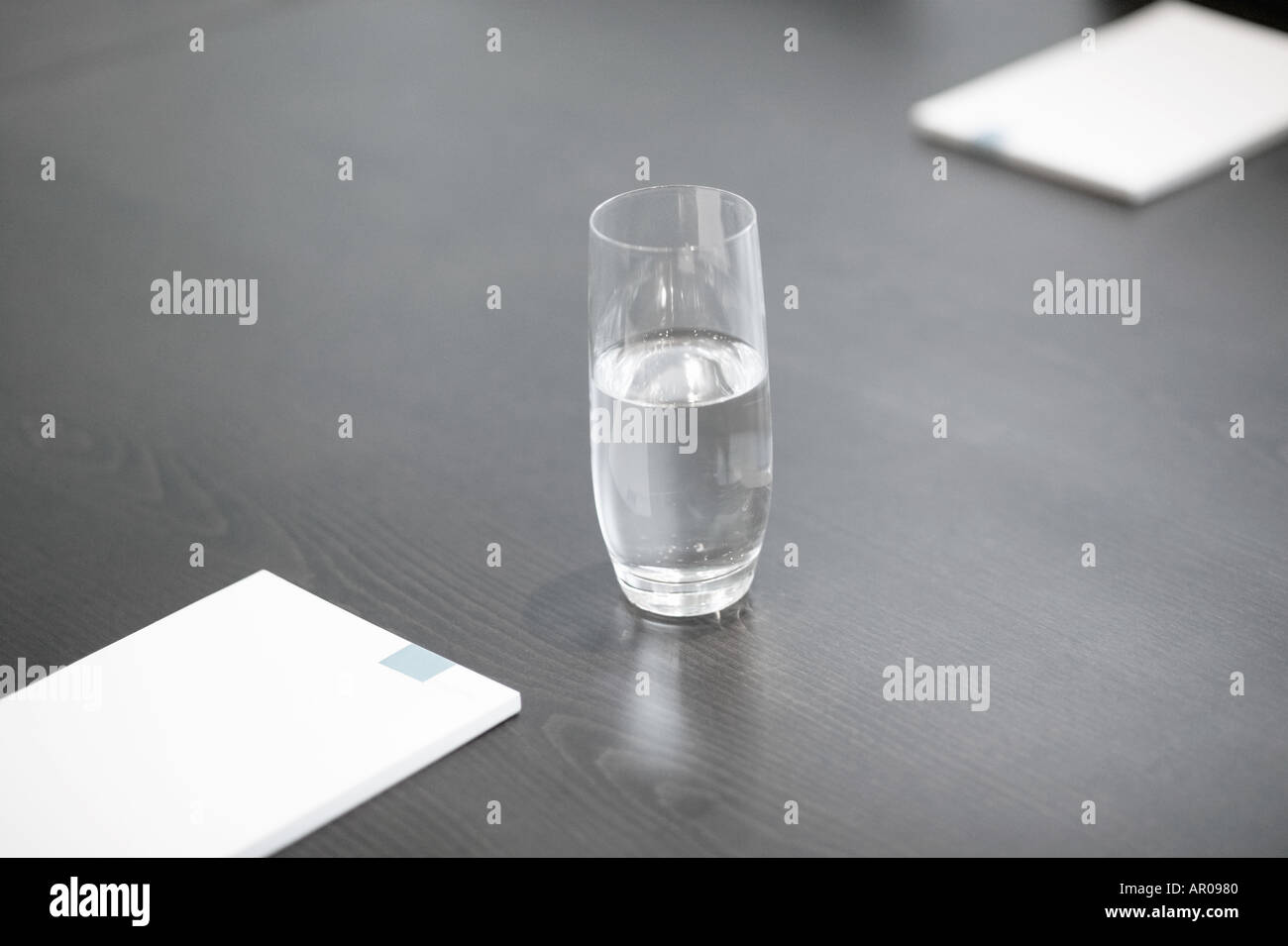 glass of water on office desk table Stock Photo - Alamy