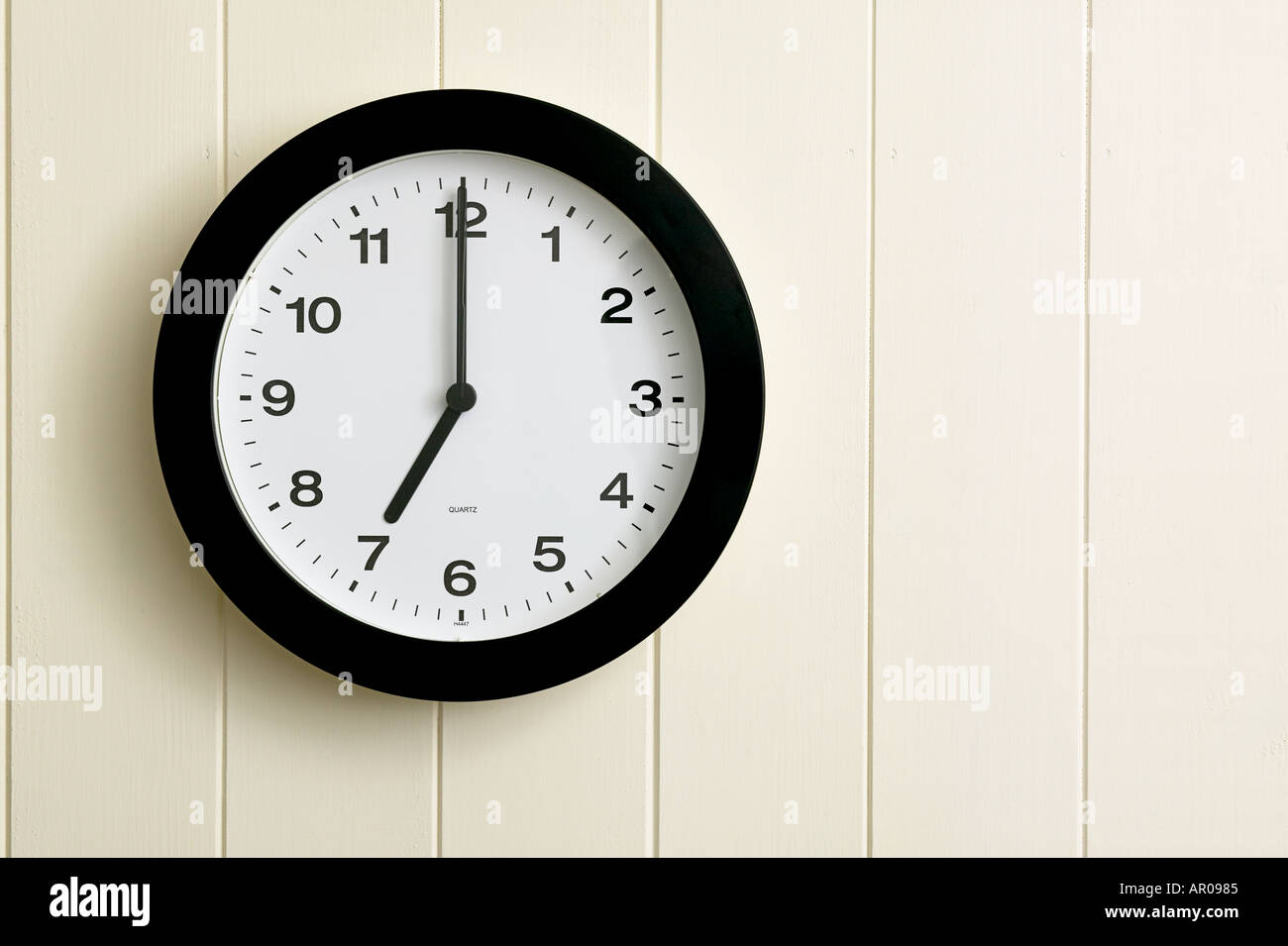 wall clock showing time at seven o clock 0700 1900 Stock Photo - Alamy