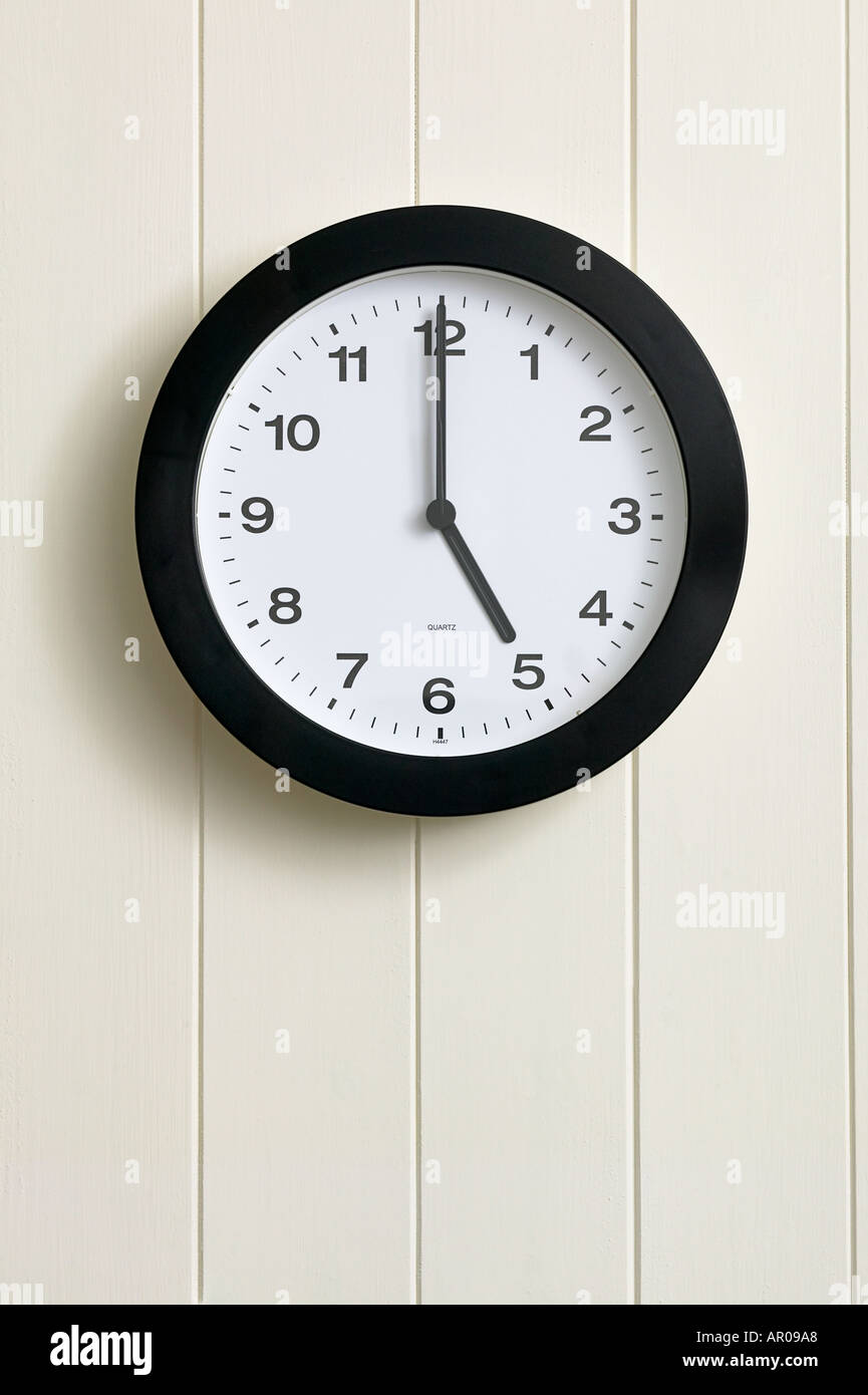 wall clock showing time at five o clock 0500 1700 Stock Photo - Alamy
