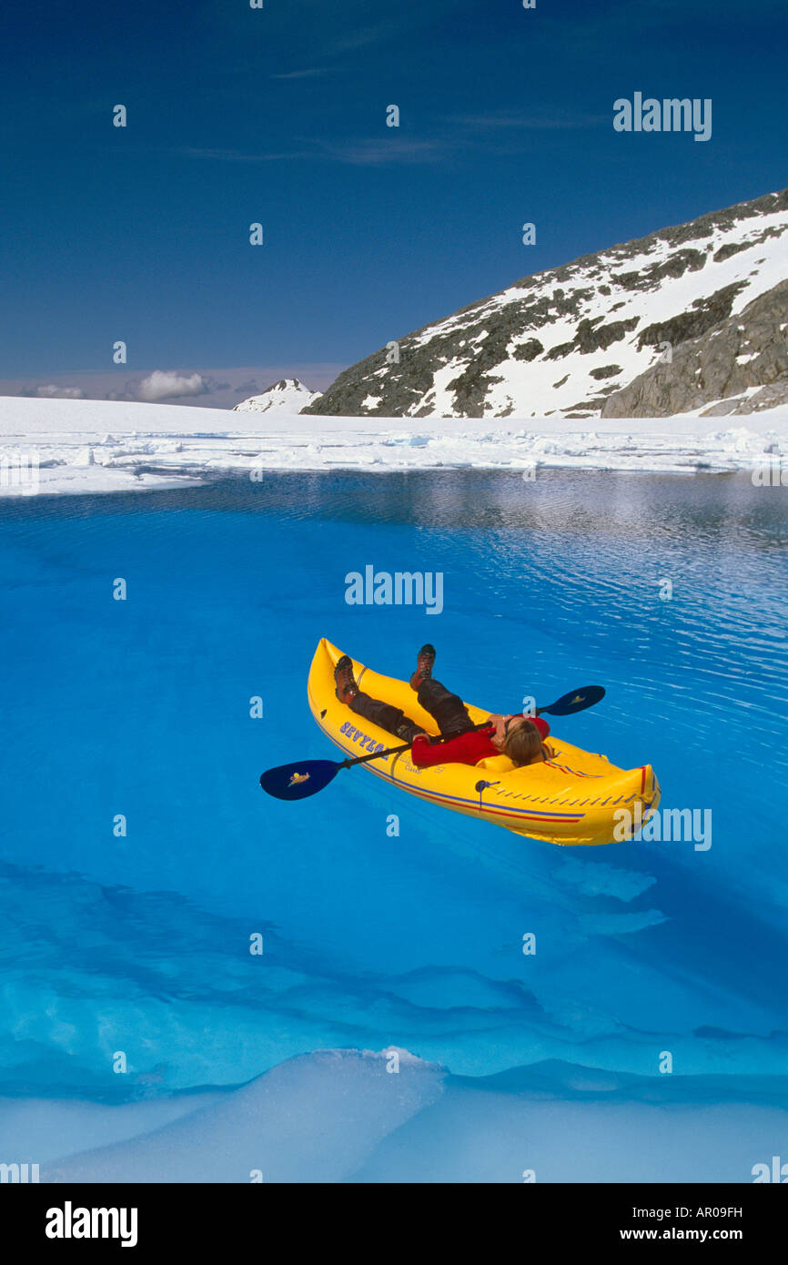 Woman Relaxing in Kayak Blue Melt Pond Juneau Icefield AK Stock Photo ...