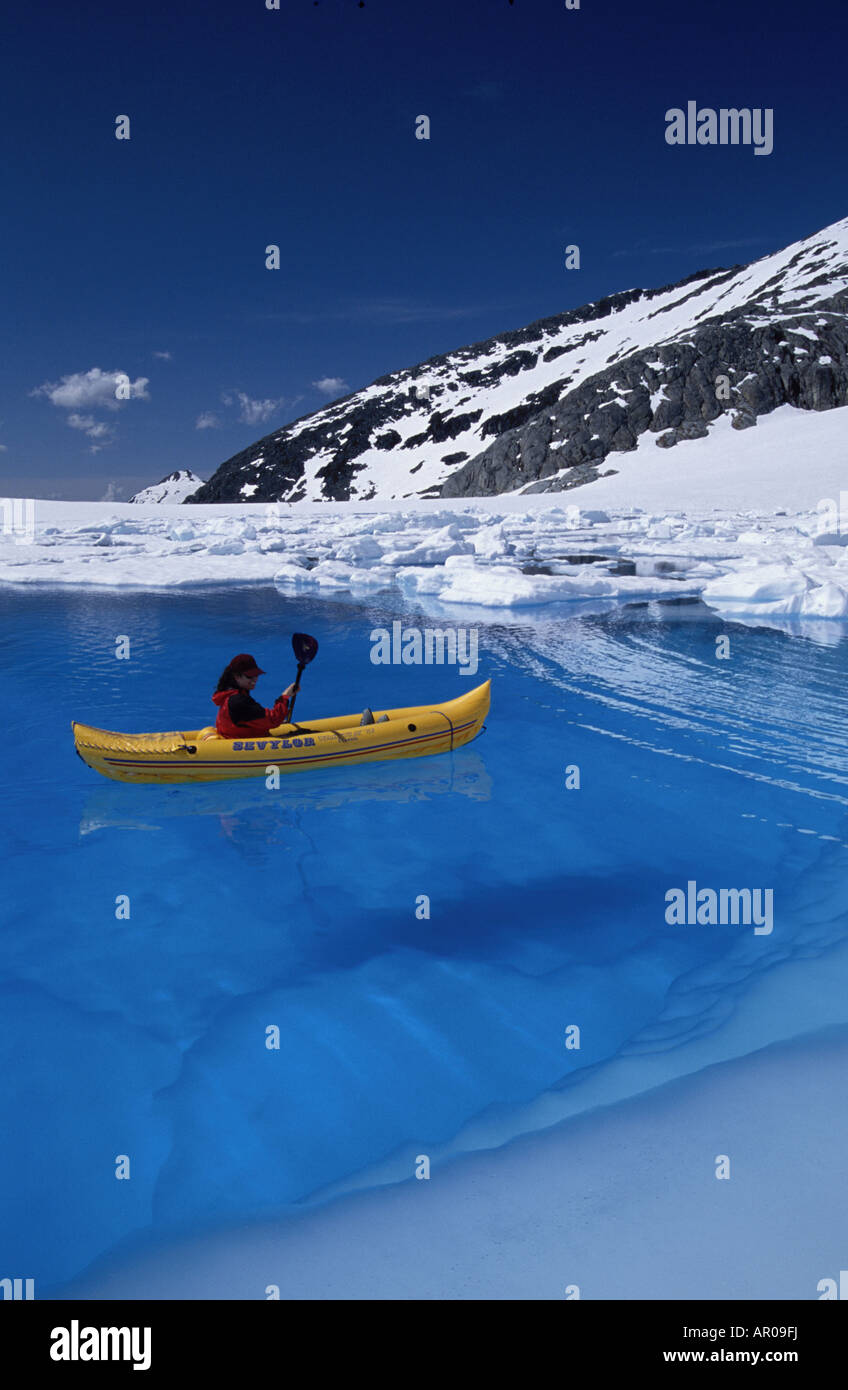 Woman Relaxing in Kayak Blue Melt Pond Juneau Icefield AK Stock Photo ...