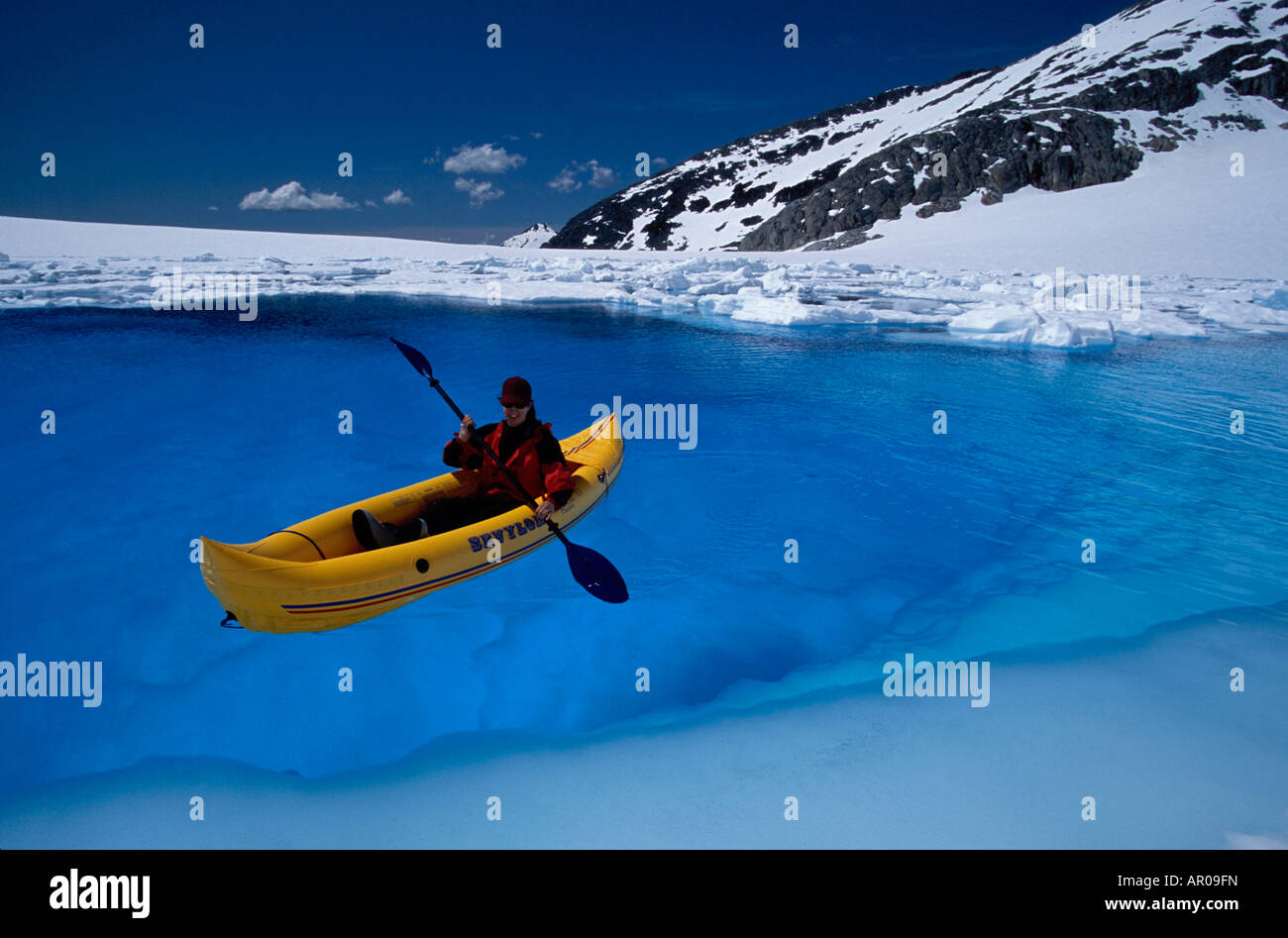 Woman Relaxing in Kayak Blue Melt Pond Juneau Icefield AK Stock Photo ...