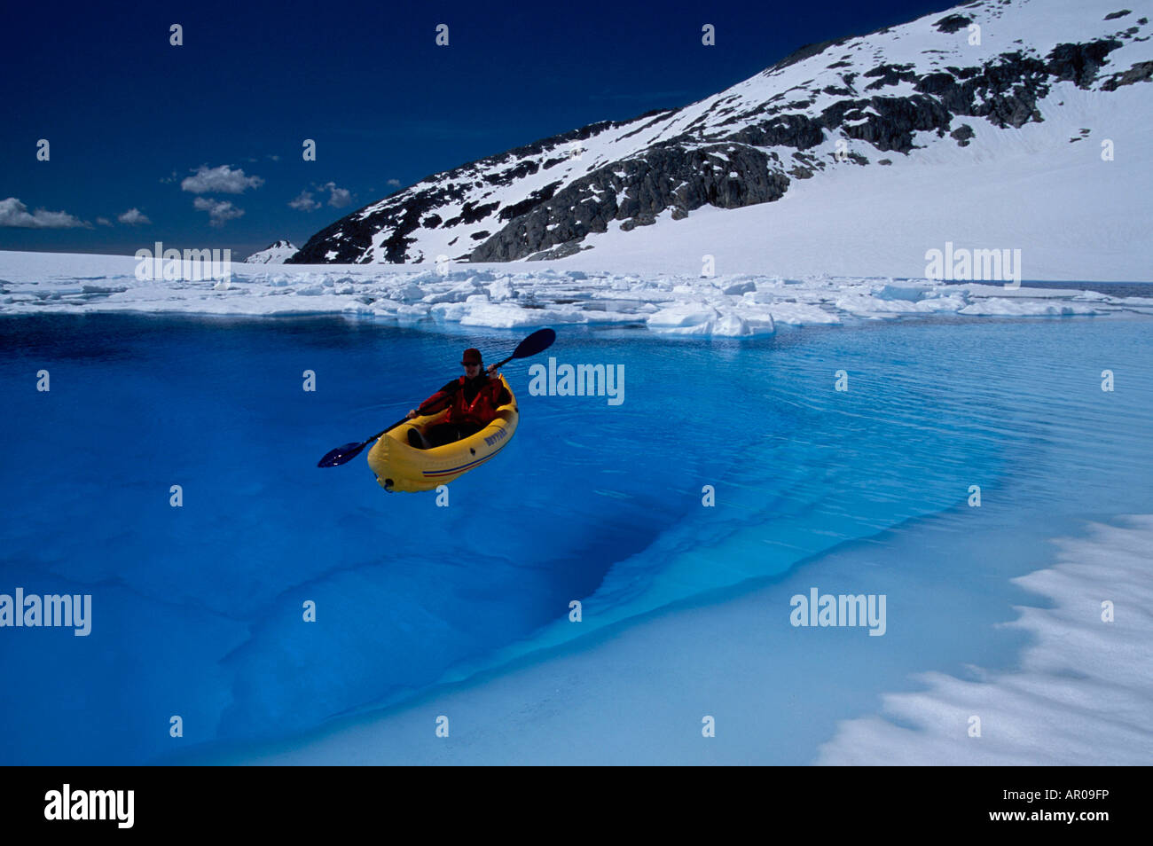Woman Relaxing in Kayak Blue Melt Pond Juneau Icefield AK Stock Photo ...