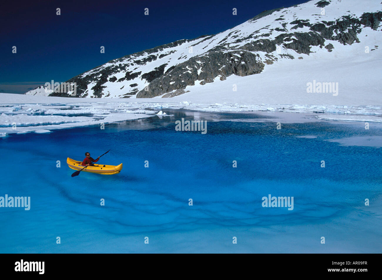 Woman Relaxing in Kayak Blue Melt Pond Juneau Icefield AK Stock Photo ...