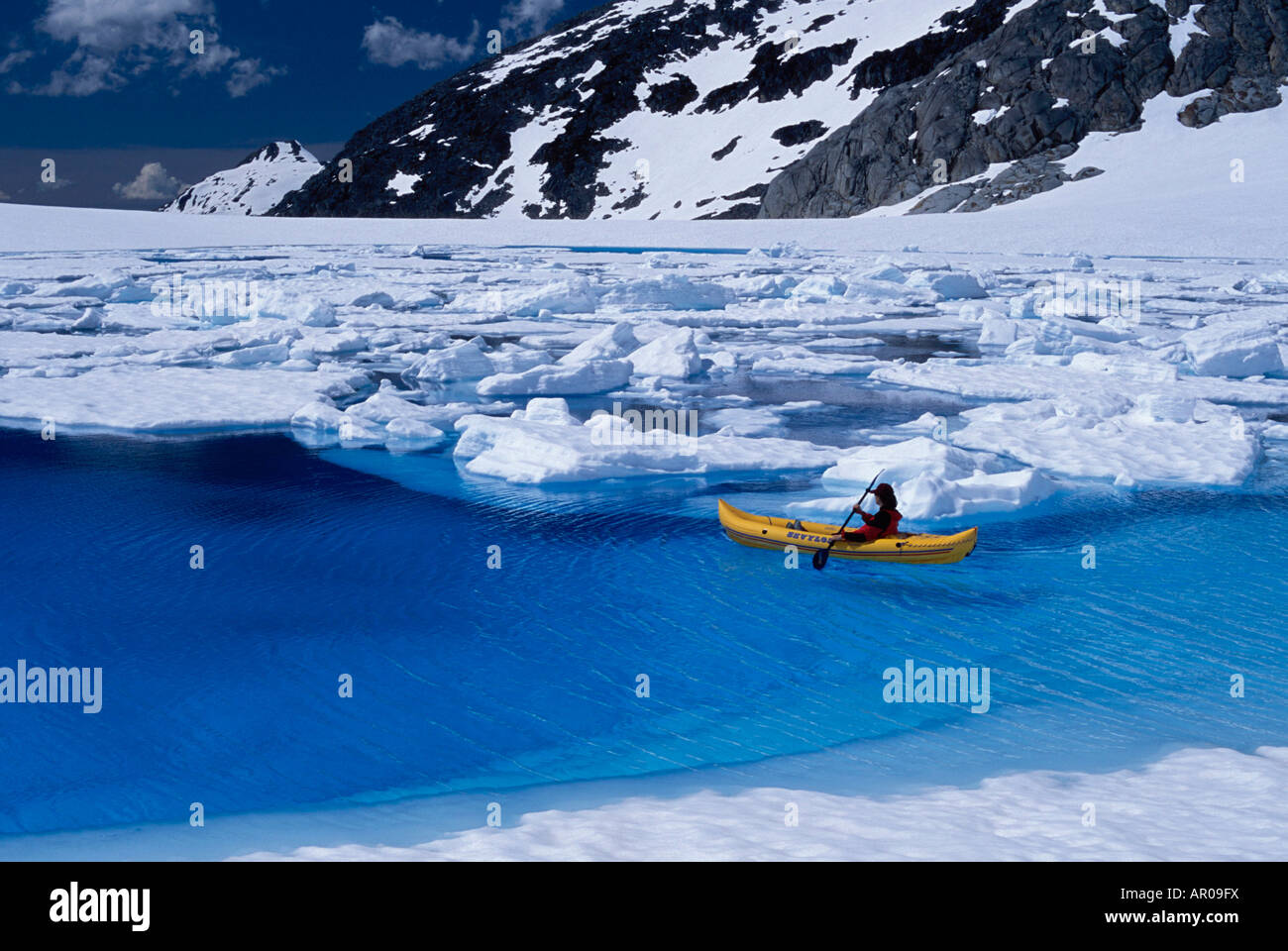 Woman Relaxing in Kayak Blue Melt Pond Juneau Icefield AK Stock Photo ...
