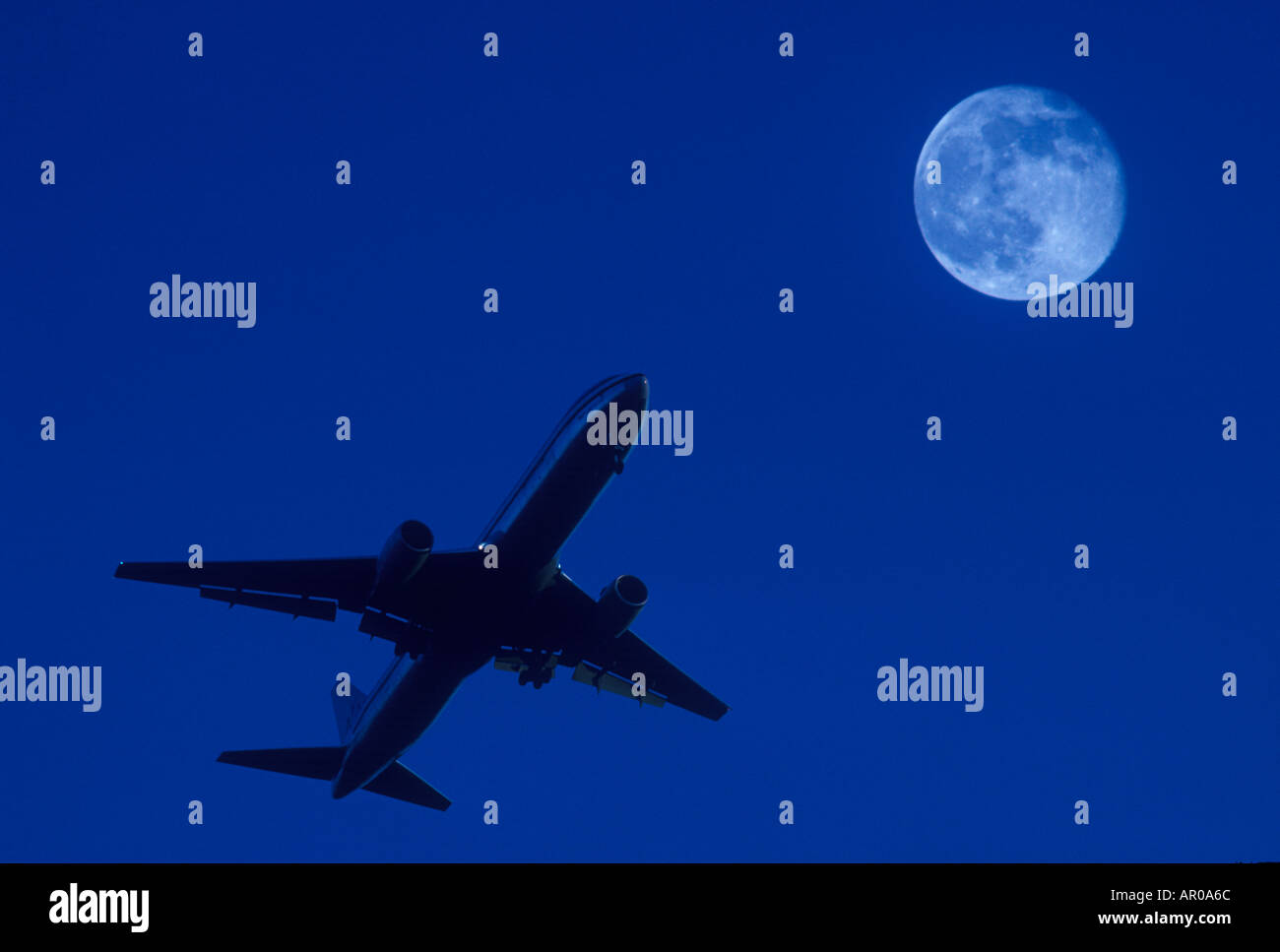 Airliner in flight by Moonlight Stock Photo - Alamy
