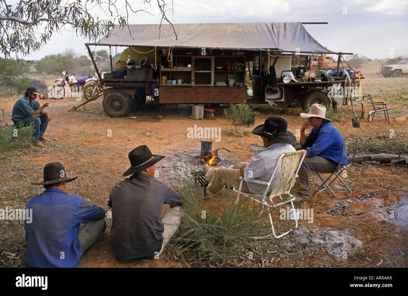 Stockmen sit around the cooks kitchen trailer, Kidman Station, South ...