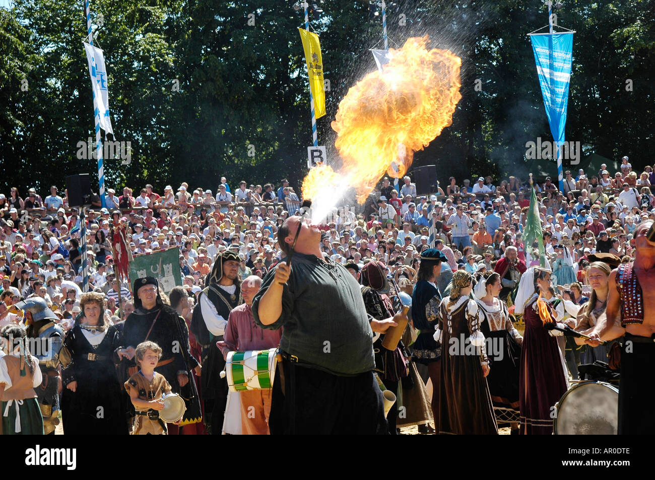 Fire-eater at move of the comedians in mediaeval medieval costume in ...