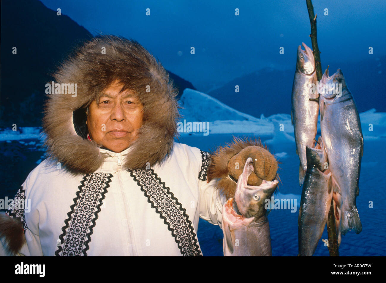 Eskimo Man with Salmon Icebergs in background AK winter portrait Stock ...