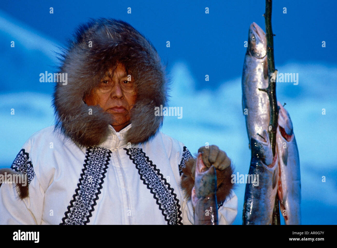 Eskimo Man with Salmon Icebergs in background AK winter portrait Stock ...