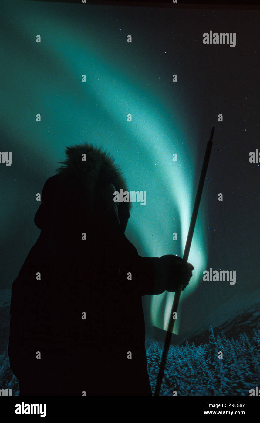 Eskimo man viewing Northern Lights over Mt Range Alaska composite ...