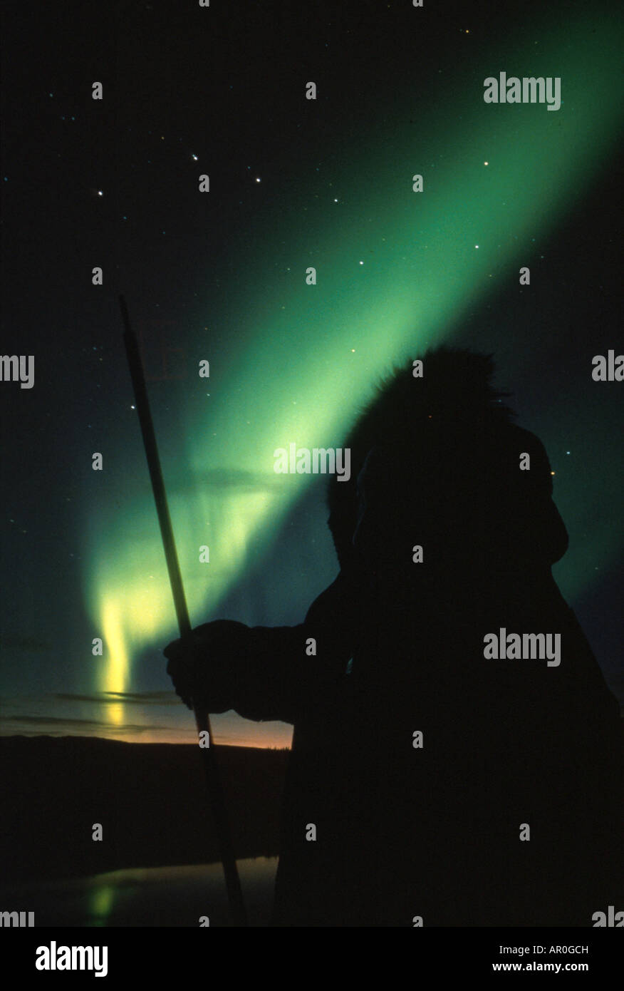 Eskimo man viewing Northern lights Alaska composite scenic Stock Photo ...