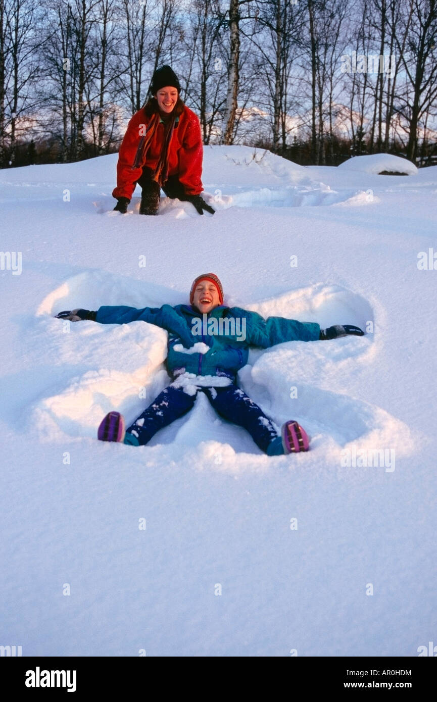 Woman & boy Making Snow Angles Anchorage SC AK Winter Stock Photo - Alamy