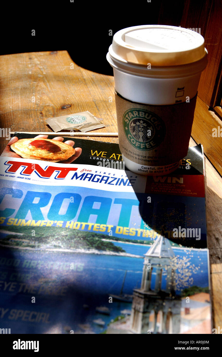 Coffee cup and a TNT Magazine on a table in the morning light Stock ...