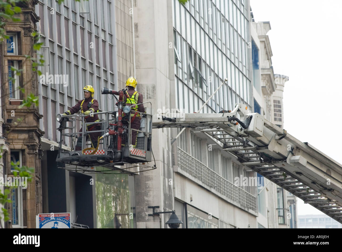 London Fire Service firemen on a platform attending an incident in ...