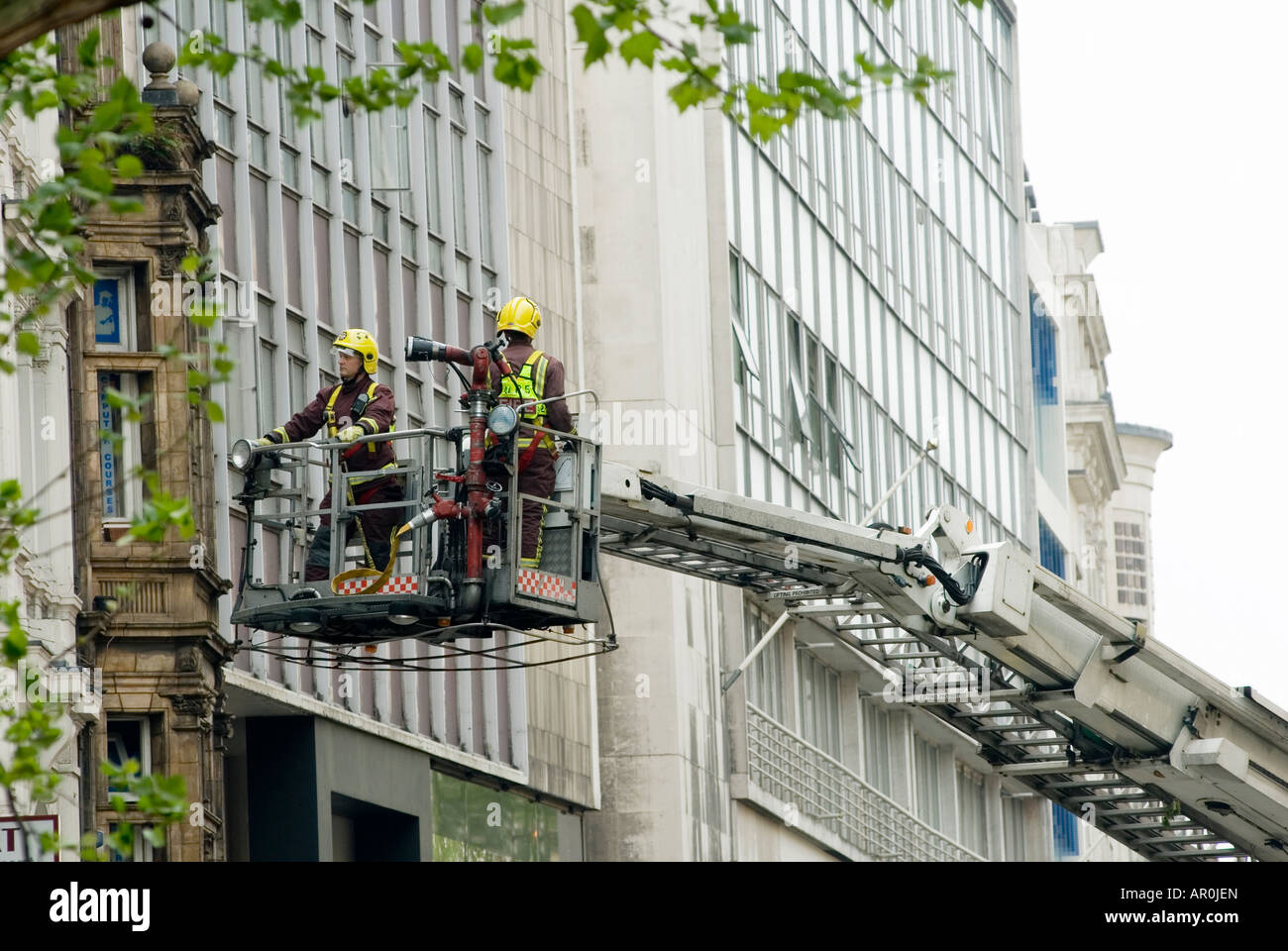 London Fire Service firemen on a platform attending an incident in ...