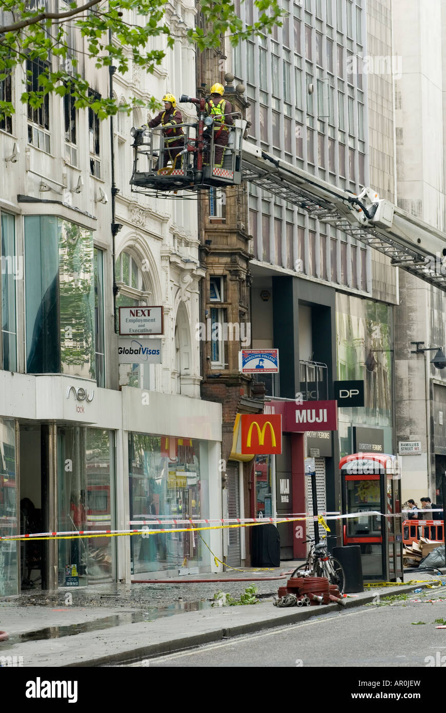 London Fire Service firemen on a platform attending an incident in ...