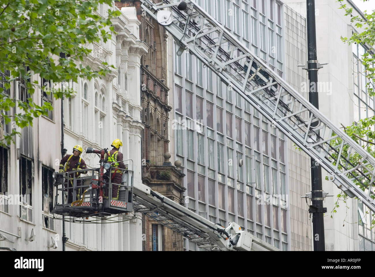 London Fire Service firemen on an extendable ladder England Stock Photo ...