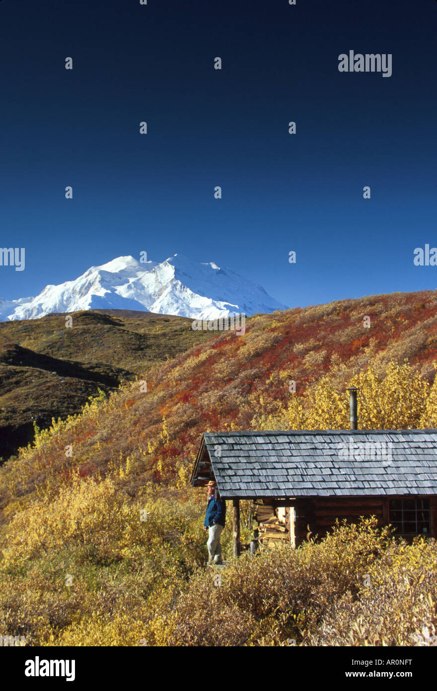 Person on porch of log cabin Mt McKinley Denali NP Int AK fall scenic ...