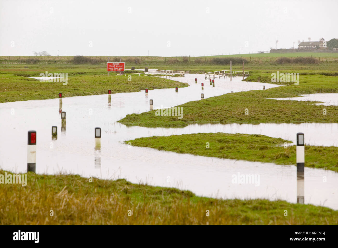 A road near Sunderland Point Morecambe Bay UK flooded by a combination ...