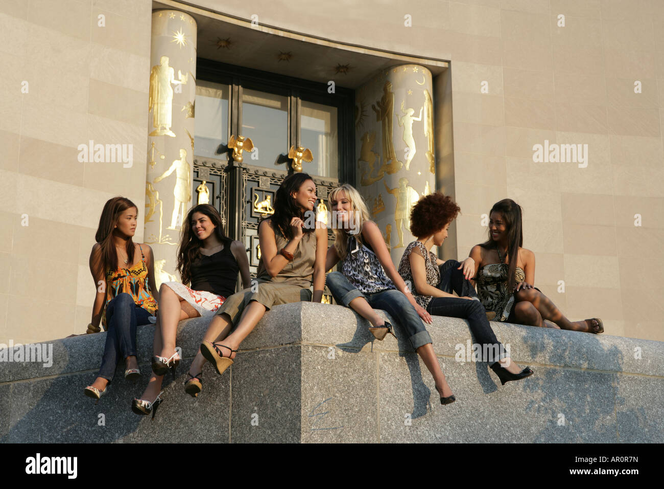 Group of people talking, sitting outdoors Stock Photo - Alamy