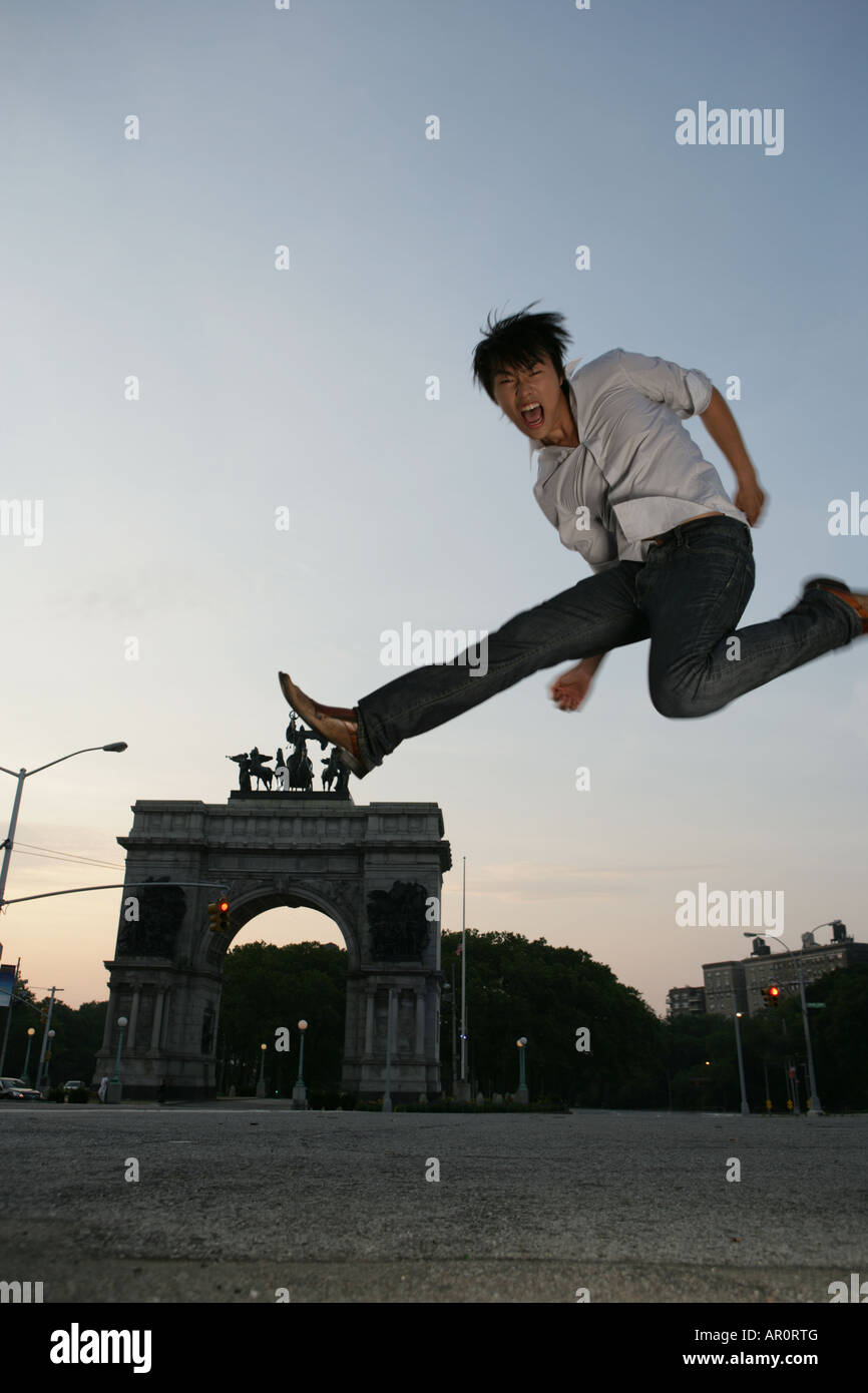 asian man jumping in brooklyn Stock Photo - Alamy