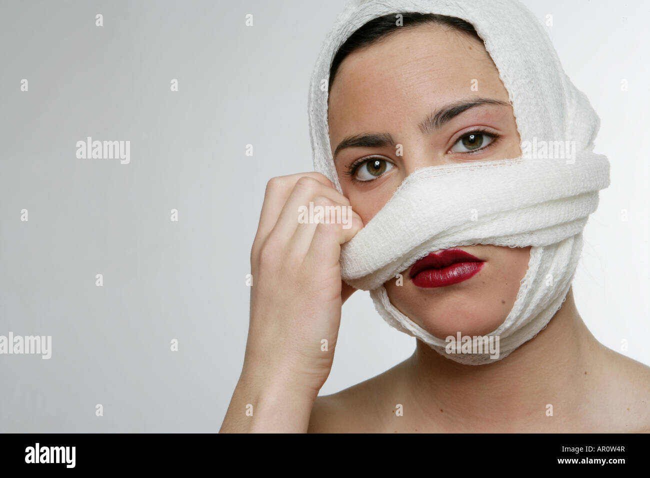 Woman with bandages around the head and face Stock Photo - Alamy
