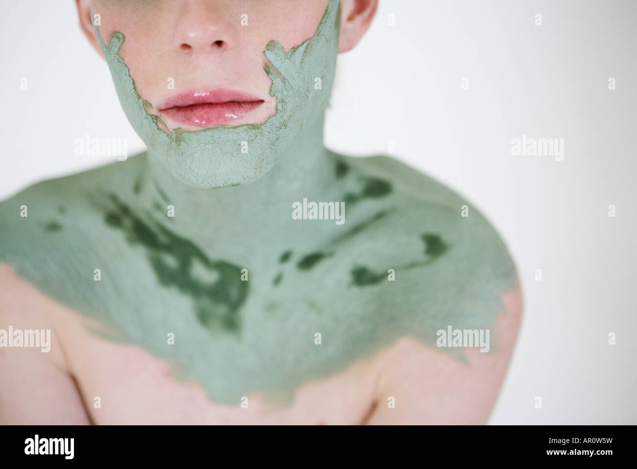 Cropped view of a woman wearing a green mask on her face, neck and ...