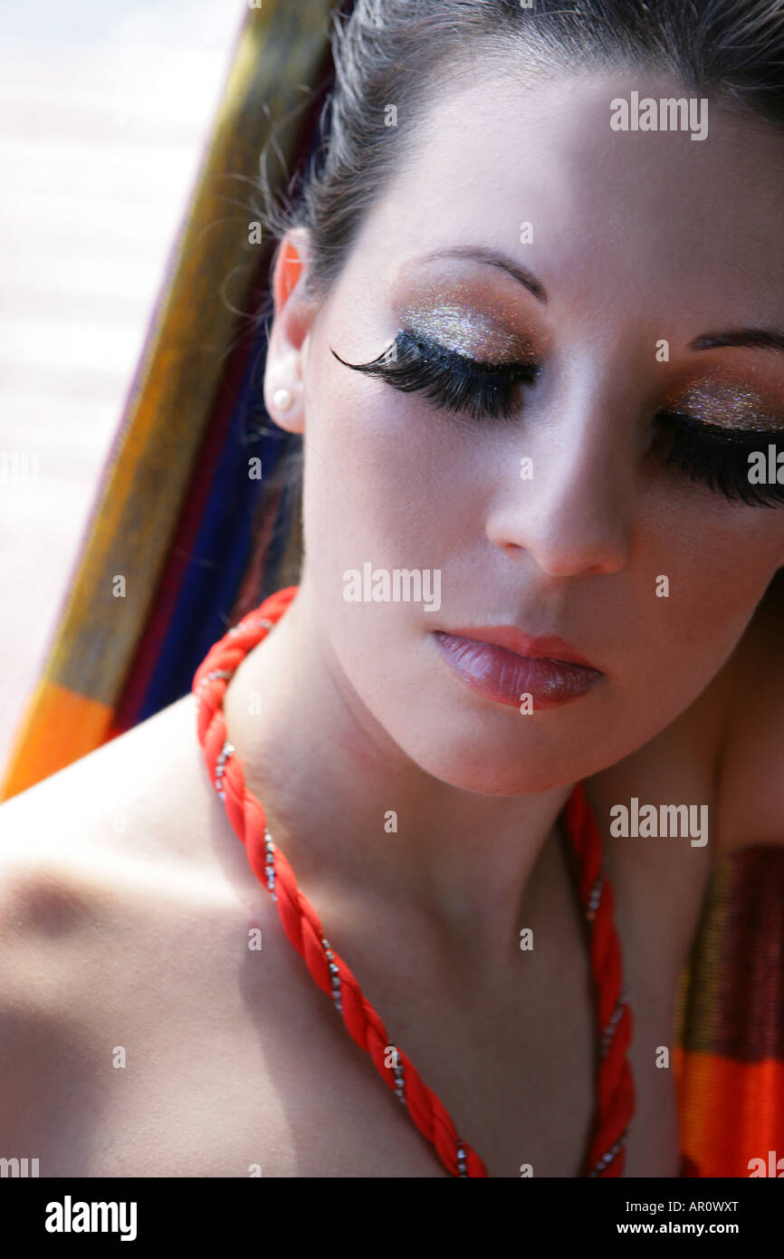 Woman facing camera, eyes closed wearing false eyelashes Stock Photo ...