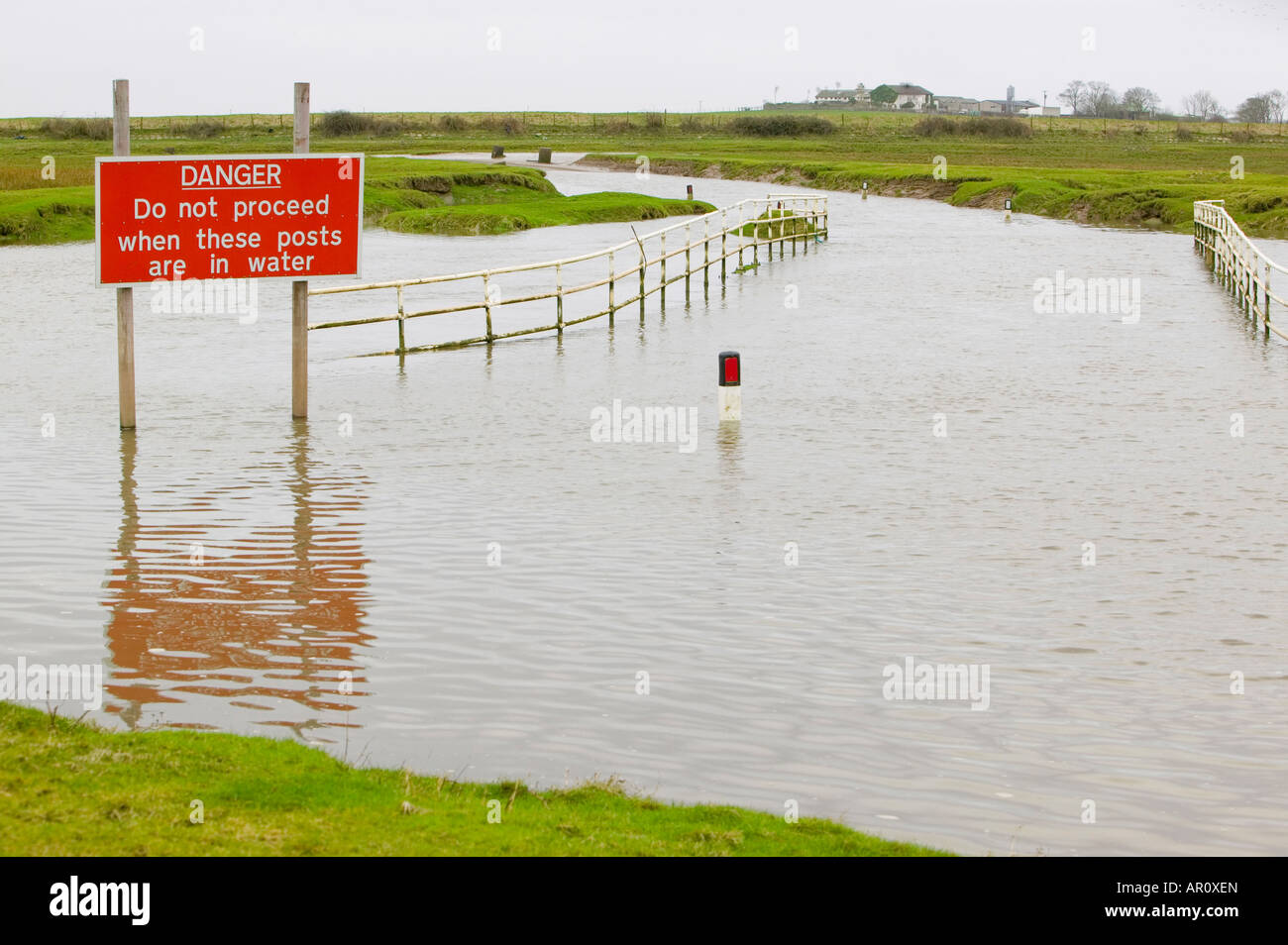 A road near Sunderland Point Morecambe Bay UK flooded by a combination ...