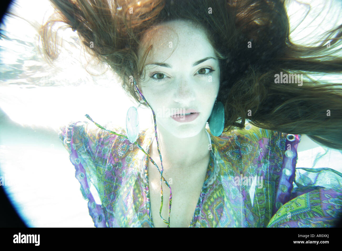 Fully-dressed young woman underwater Stock Photo - Alamy