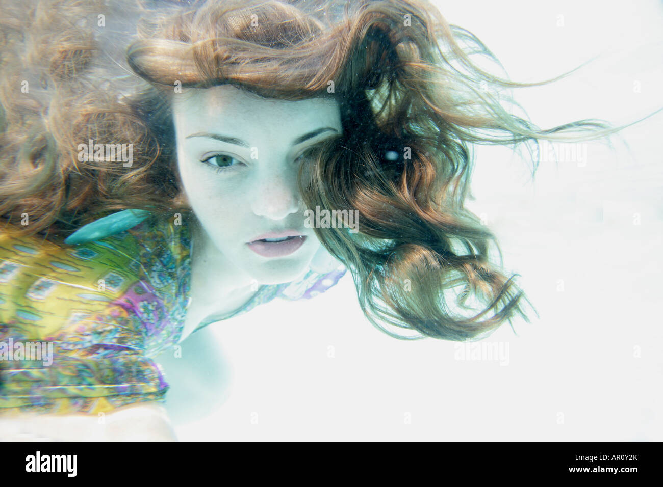 Young woman floating underwater Stock Photo - Alamy