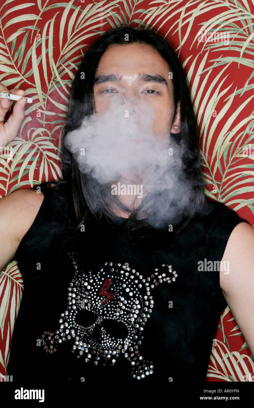 Punk rocker blowing smoke Stock Photo - Alamy