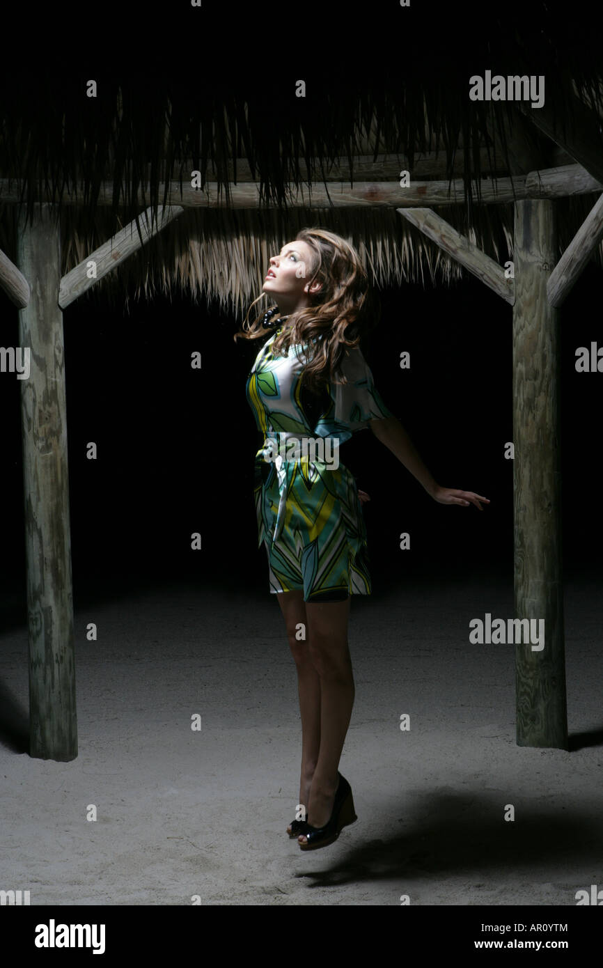 Young woman floating towards the light Stock Photo - Alamy