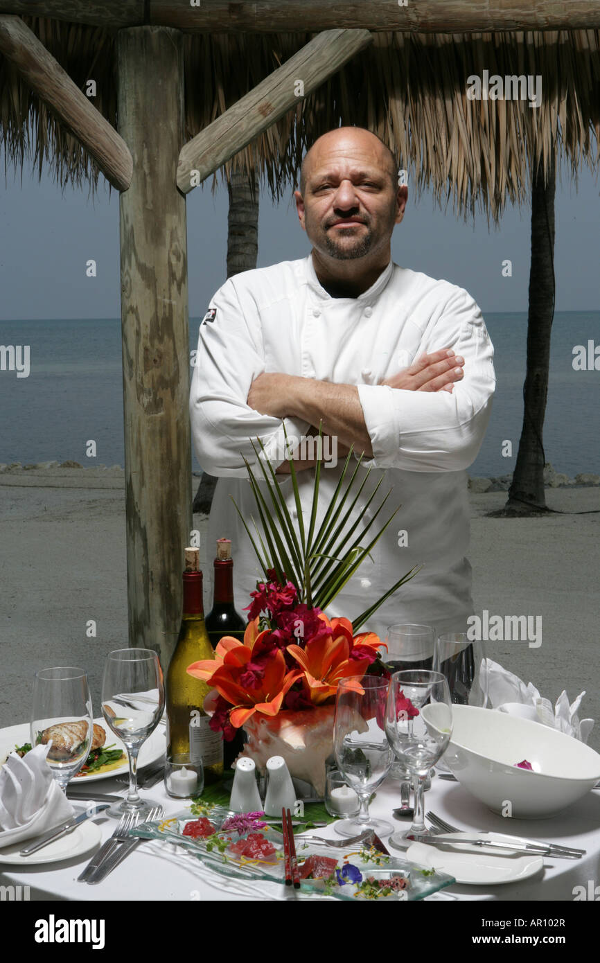 Chef standing in front of table at beach Stock Photo - Alamy