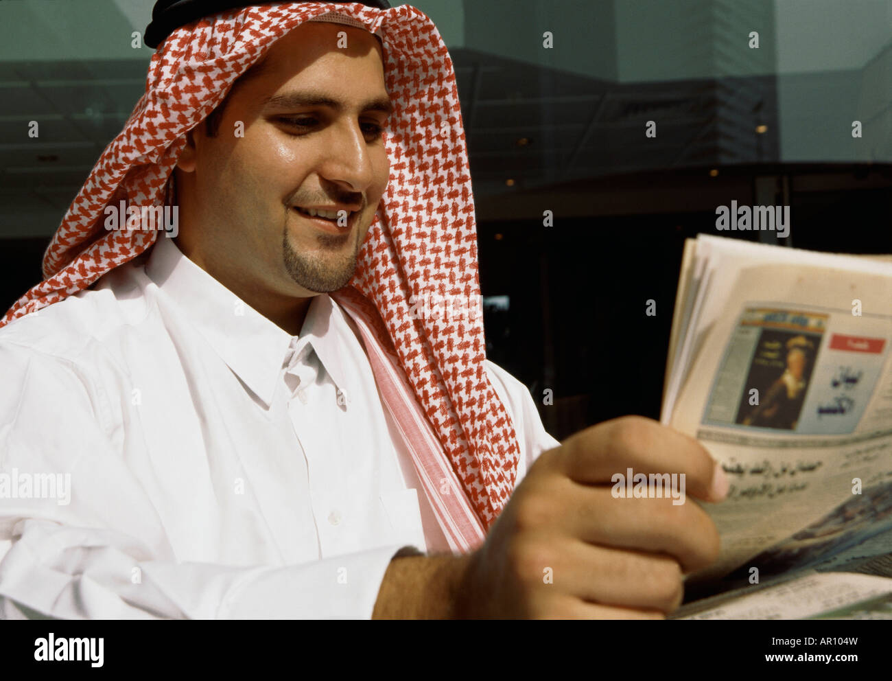 Arab Man Reading newspaper in Arabic Language Stock Photo - Alamy