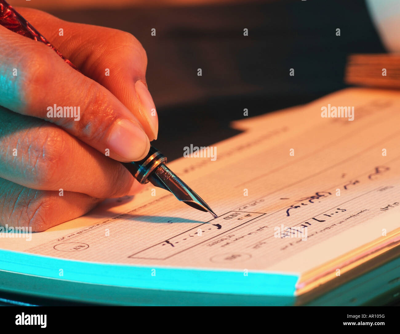 Writing a cheque Stock Photo - Alamy