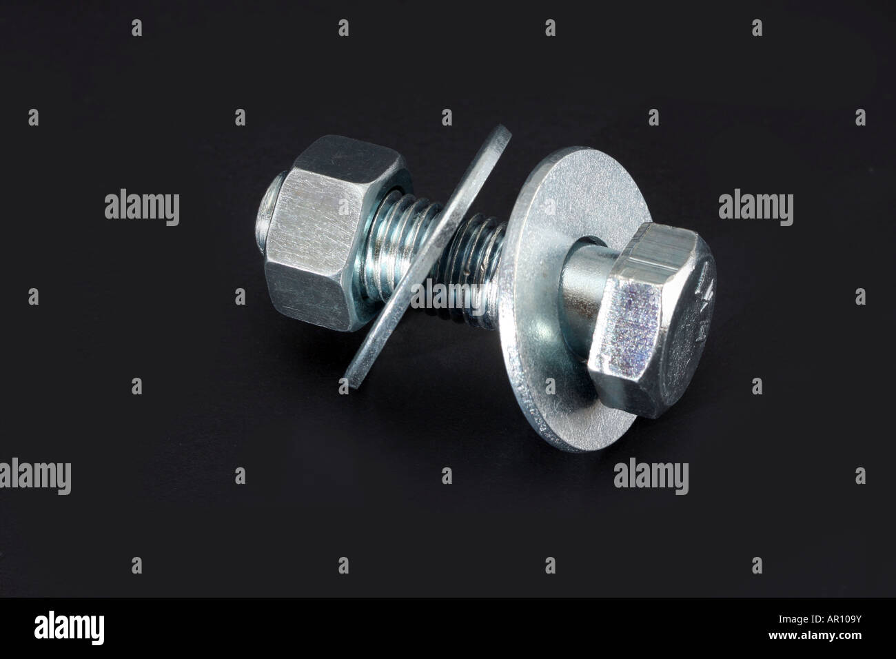 A bolt with washers and nut attached Stock Photo - Alamy