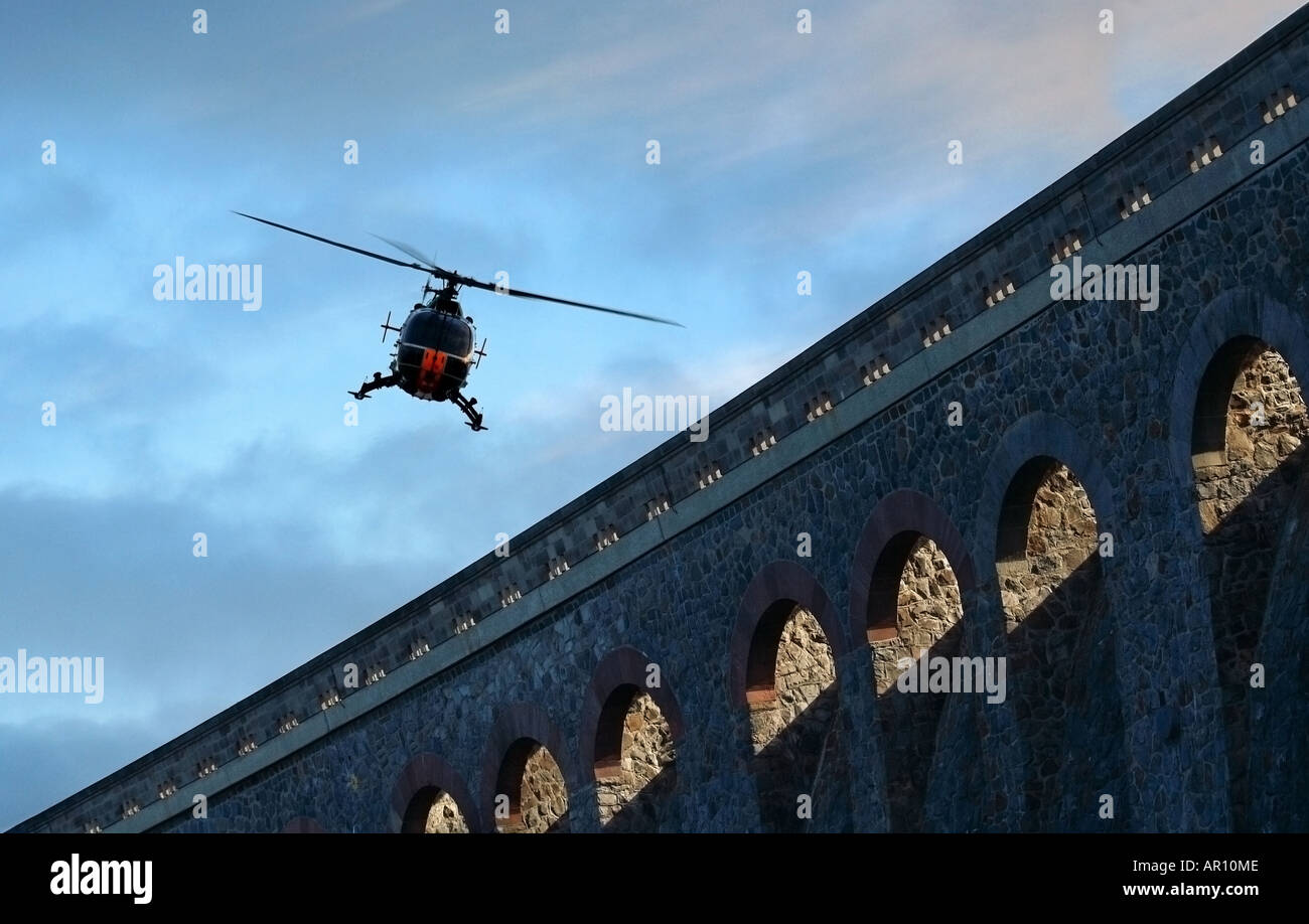 Helicopter flying over a retaining wall Stock Photo - Alamy