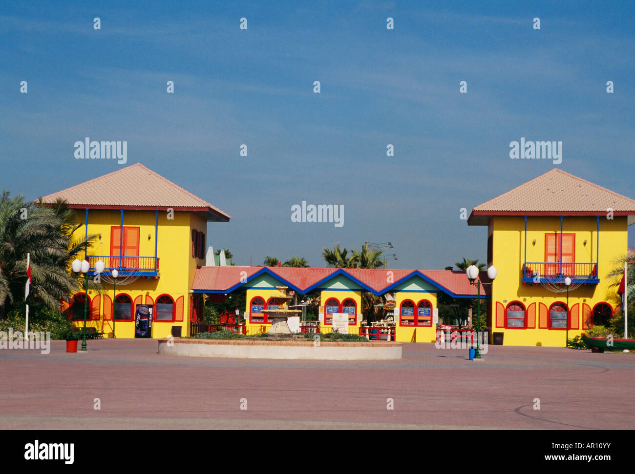 Front view of a yellow colored building having tapering roofs Stock ...