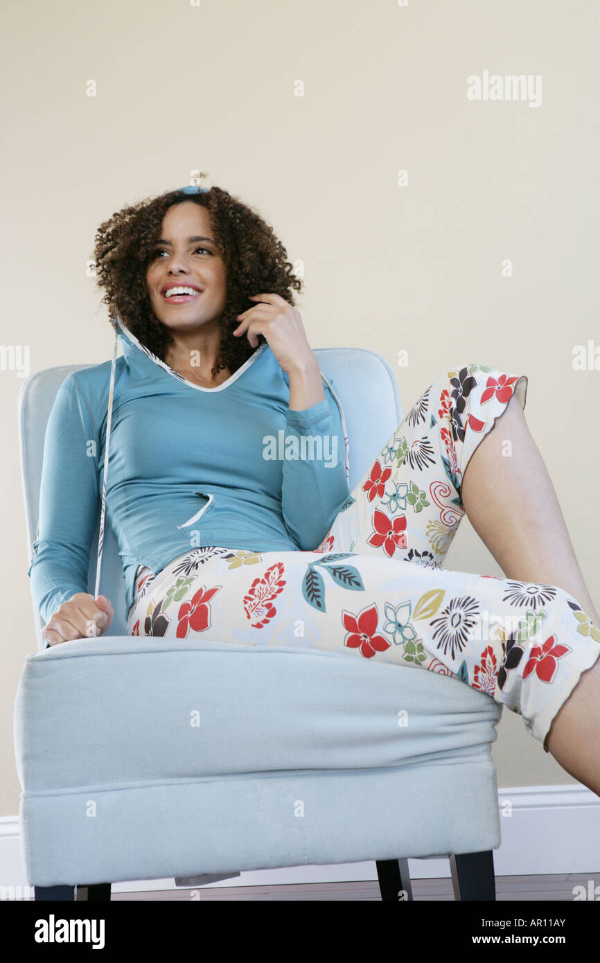 Young woman relaxing on a chair Stock Photo - Alamy