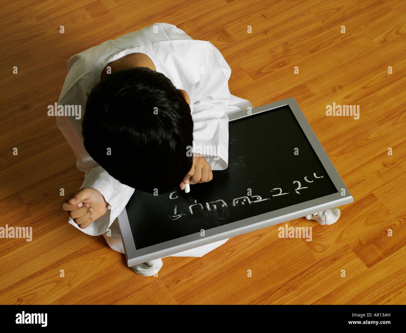 Arab Boy writing on slate Stock Photo - Alamy