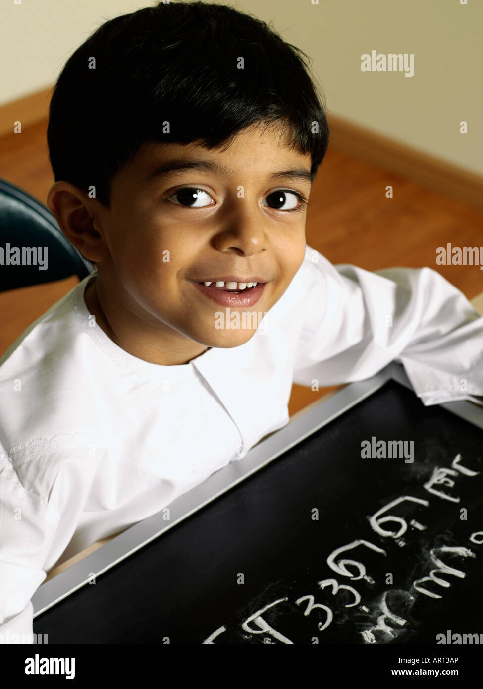 Arab Boy holding Slate with Arabic letters on it Stock Photo - Alamy