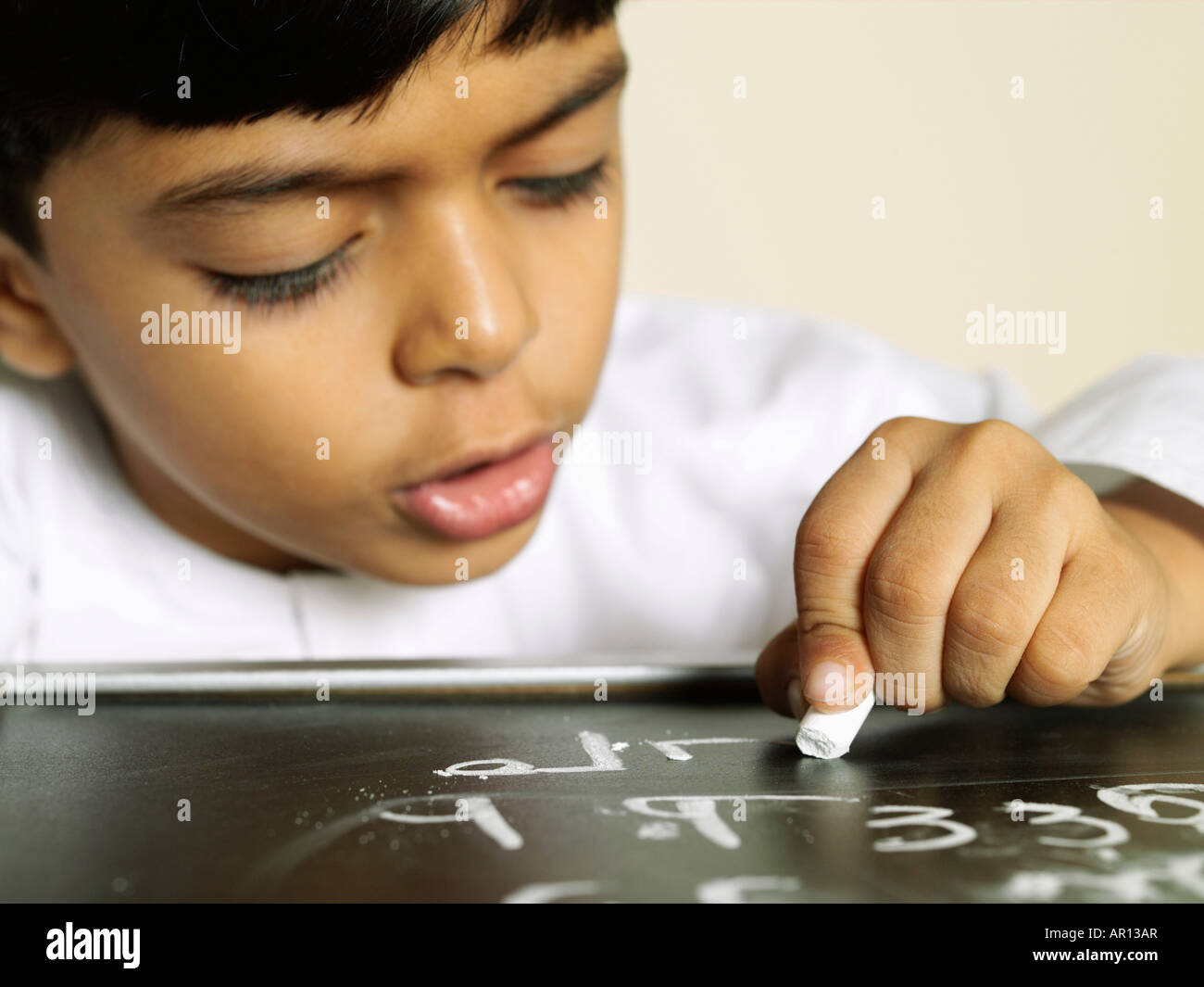 Arab Boy writing on slate Stock Photo - Alamy