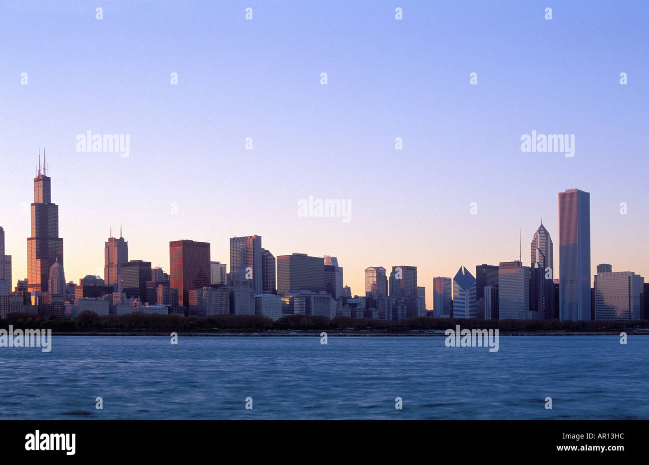 The last rays of sun hit the tall skyscrapers of Chicago skyline at ...