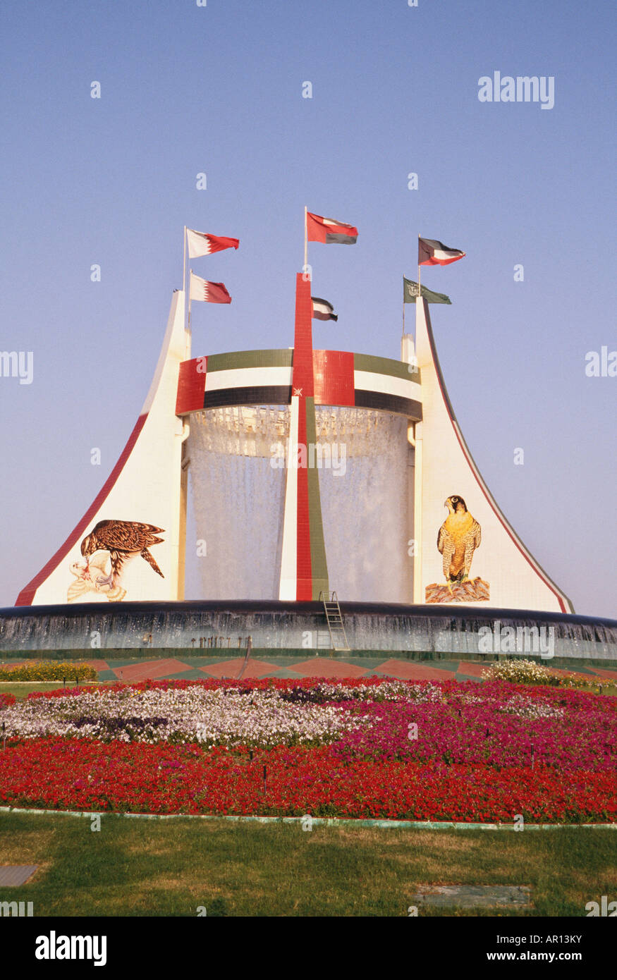 Flags hoisted on the water fountain as seen amidst lawn Stock Photo - Alamy
