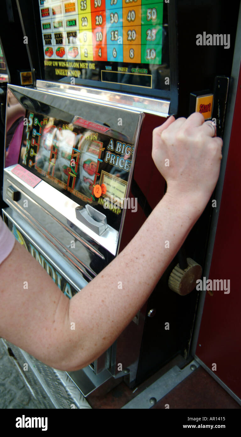 Girl playing fruit machine hi-res stock photography and images - Alamy