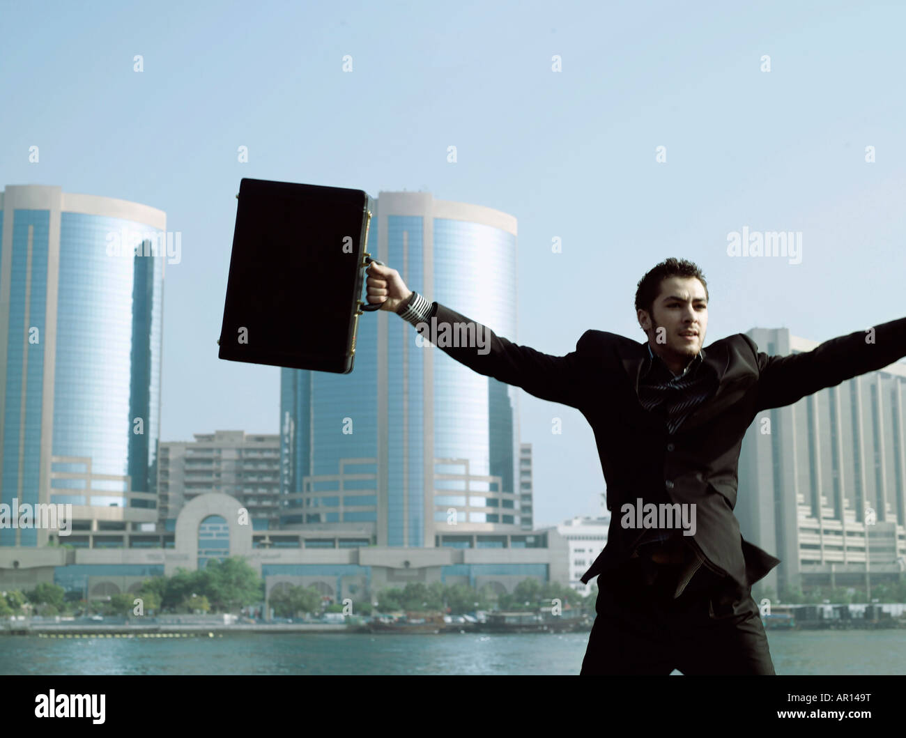 Young Businessman jumping outside the building Stock Photo - Alamy