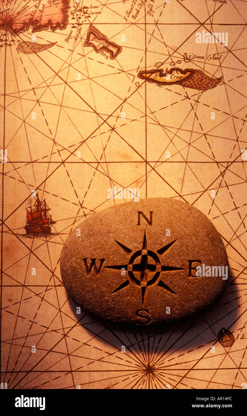 Stone compass on old map Stock Photo - Alamy